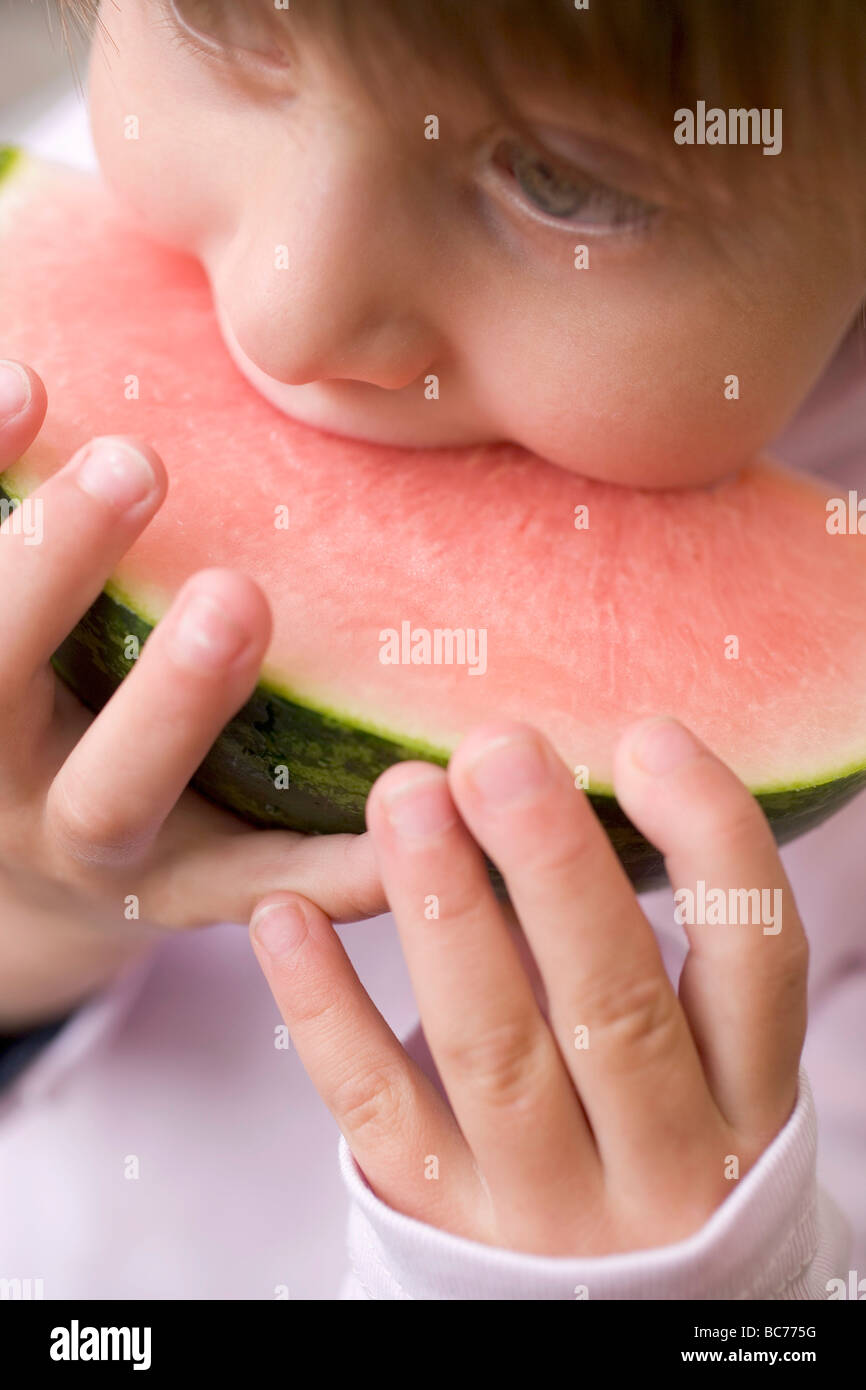 Child biting into watermelon Stock Photo - Alamy