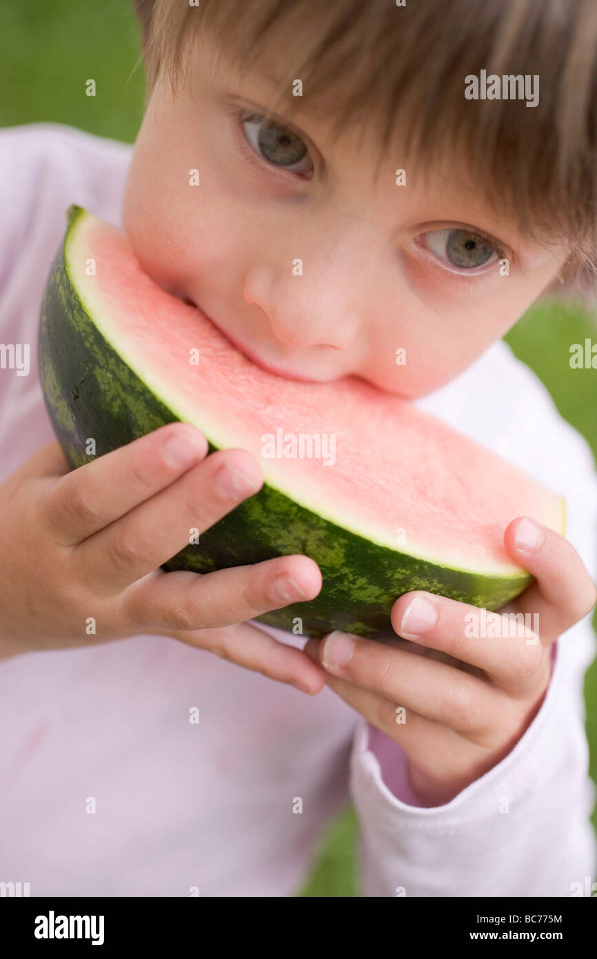 Child biting into watermelon Stock Photo - Alamy