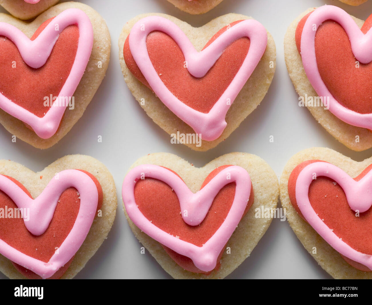 Heart-shaped biscuits with red icing Stock Photo - Alamy