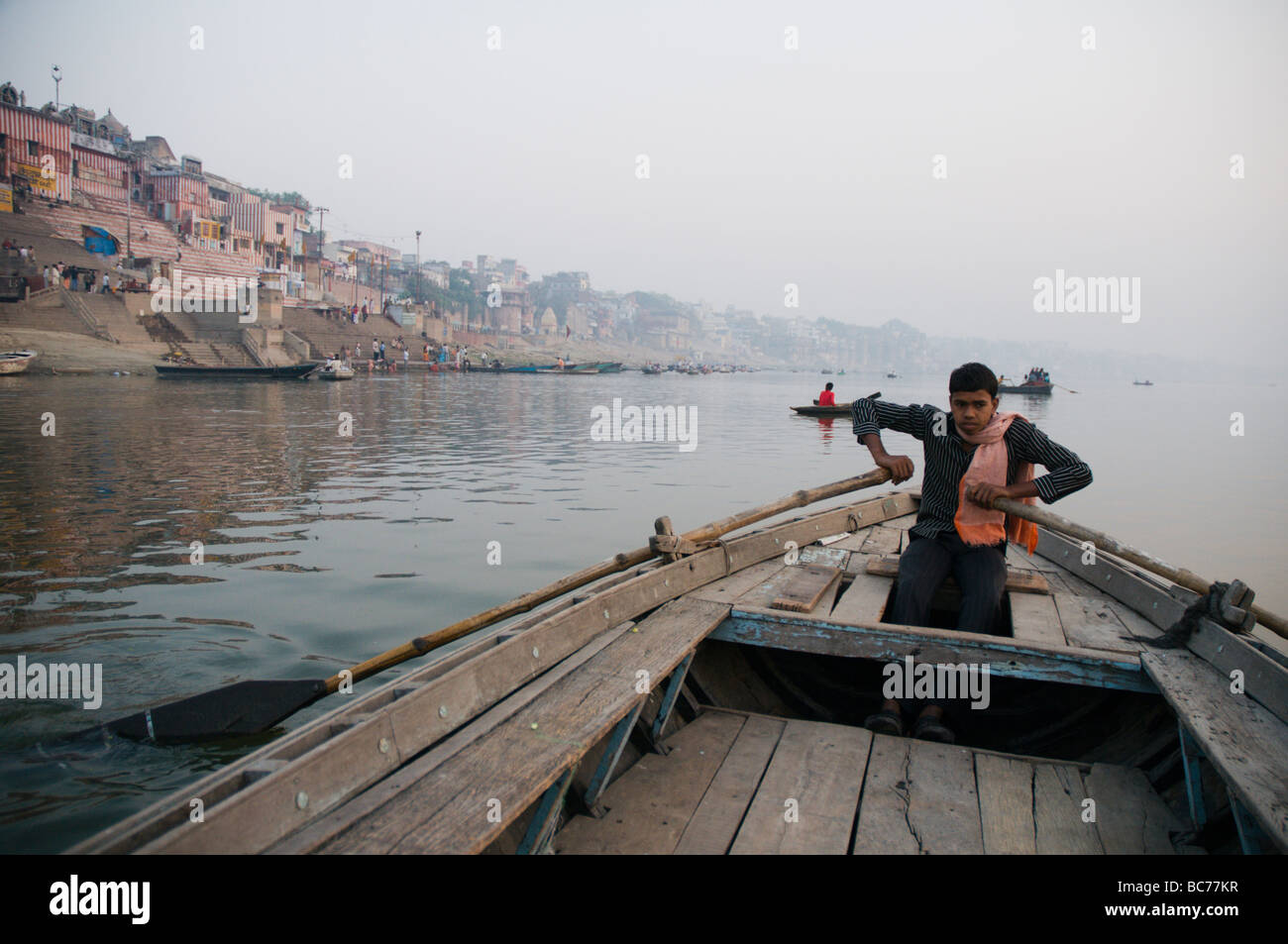 indian boy rowing along the river ganges, varanasi Stock Photo - Alamy