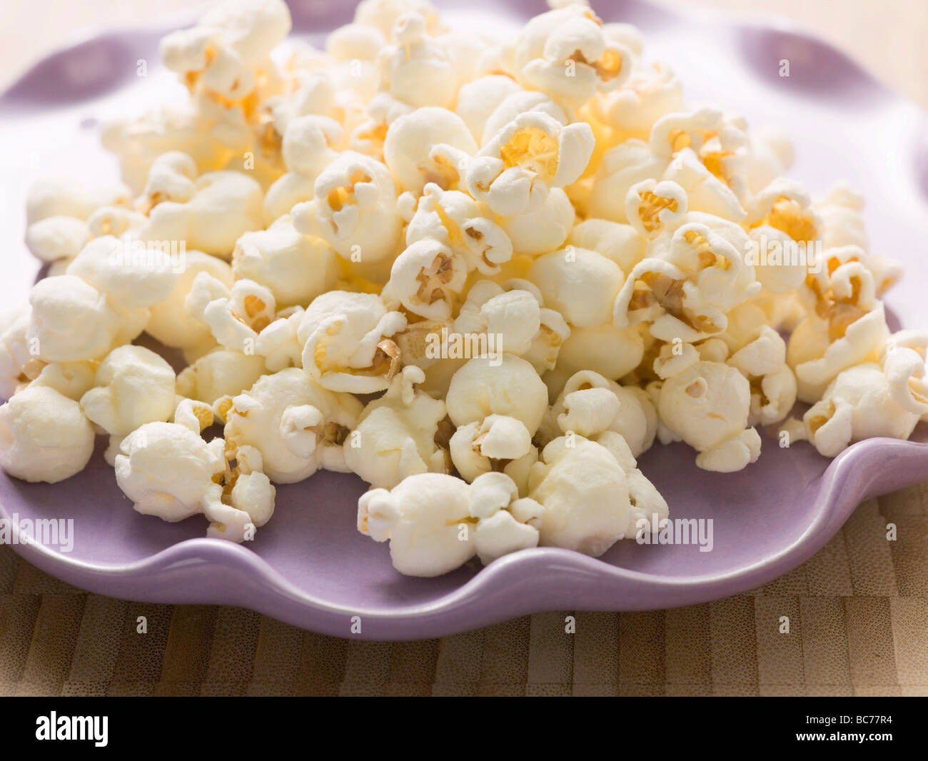 Popcorn on purple plate Stock Photo - Alamy