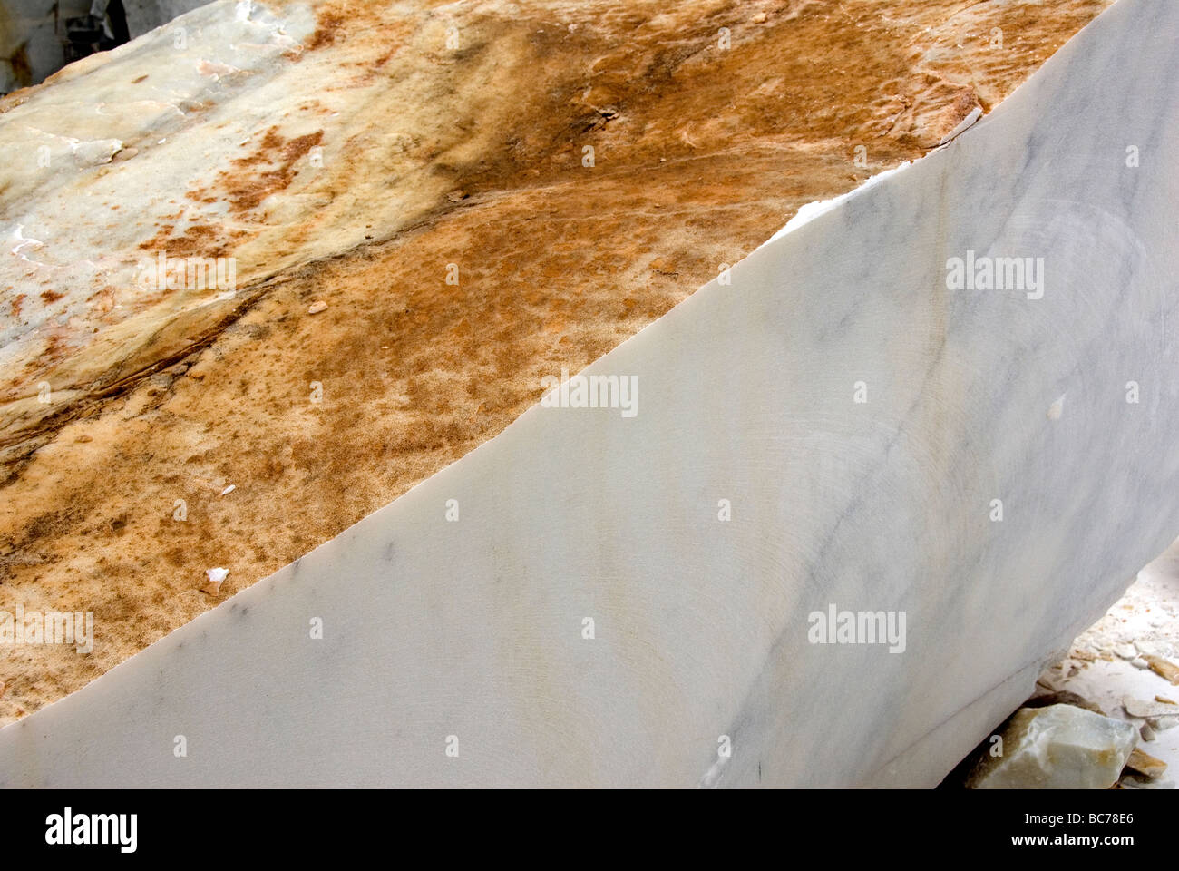 Freshly cut slab of Marble still in the quarry with orange surface ...