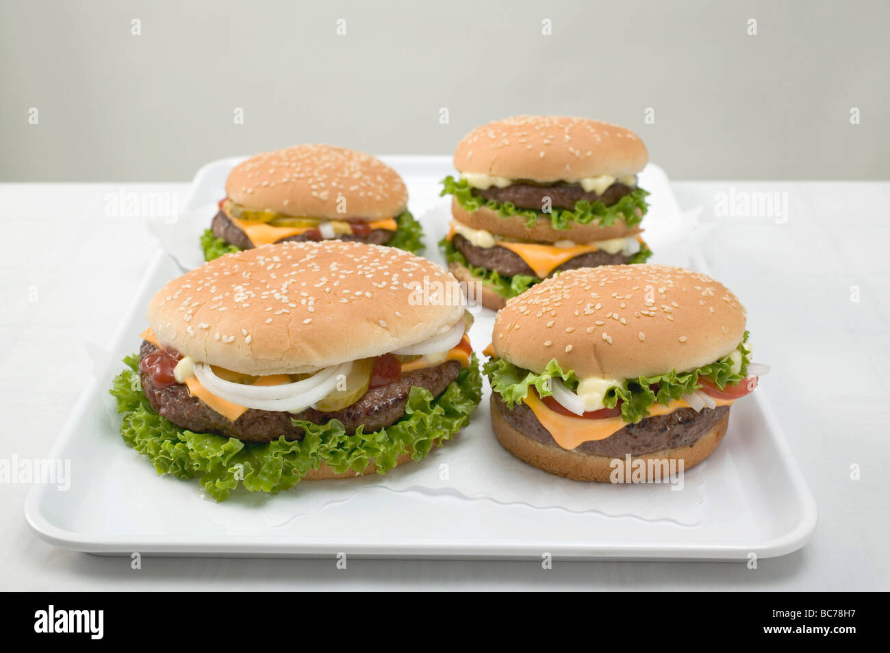 Four cheeseburgers on tray Stock Photo - Alamy