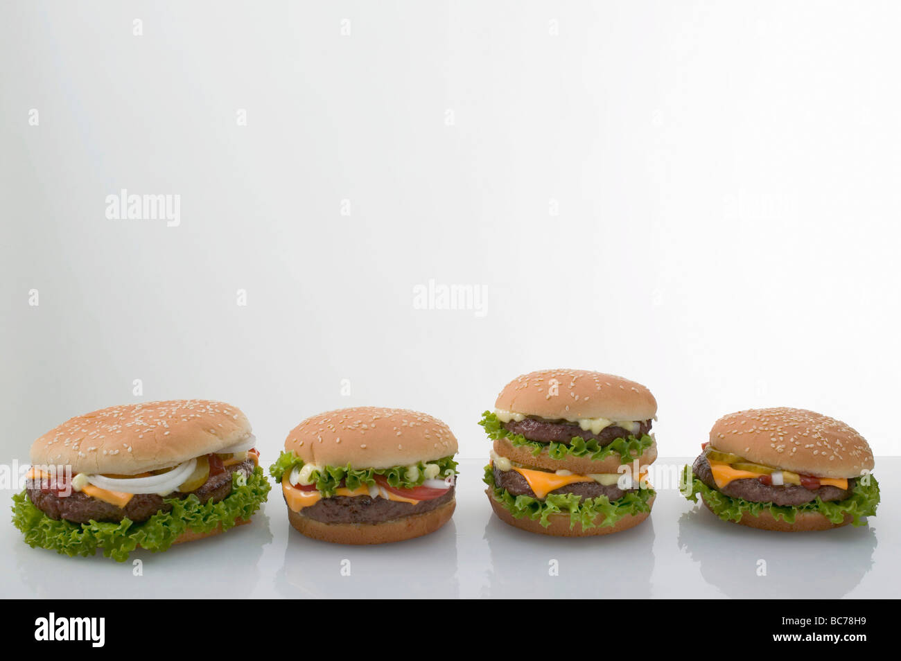 Four cheeseburgers in a row Stock Photo - Alamy