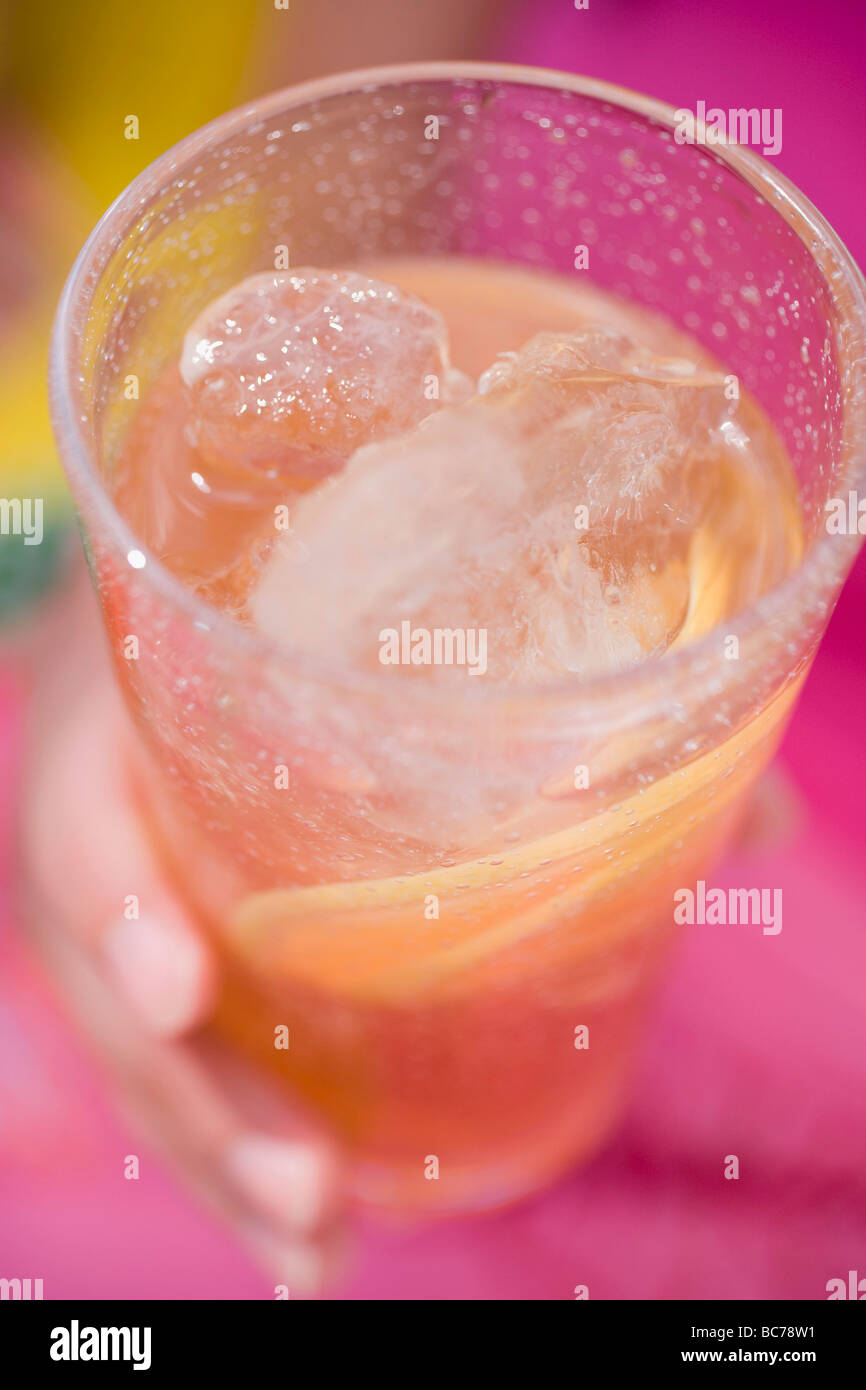 Hand holding a glass of iced tea Stock Photo - Alamy