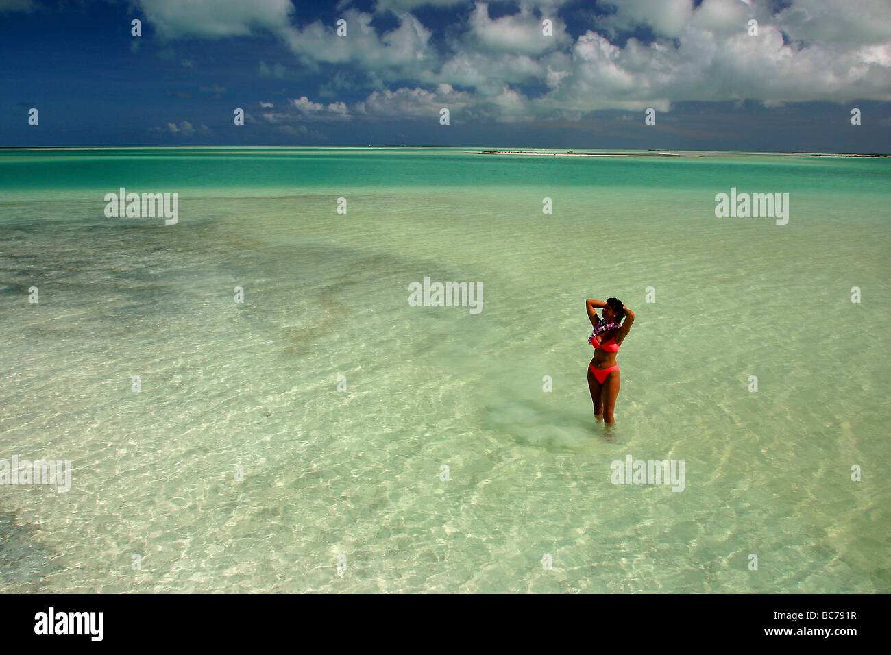 Woman wading in shallow tropical lagoon, returning from a swim Stock ...