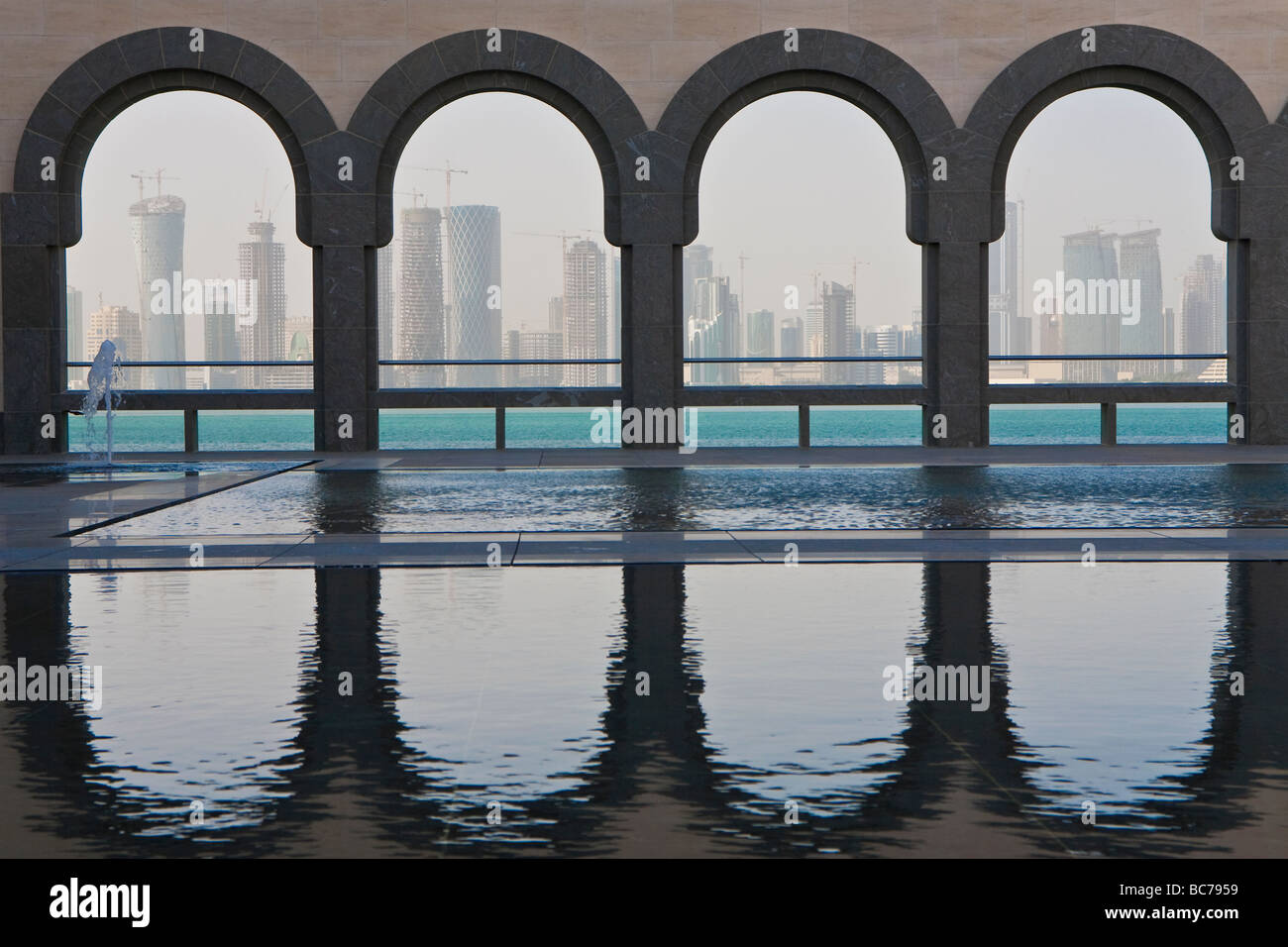 The Doha skyline shot through traditional arches from inside the Museum ...