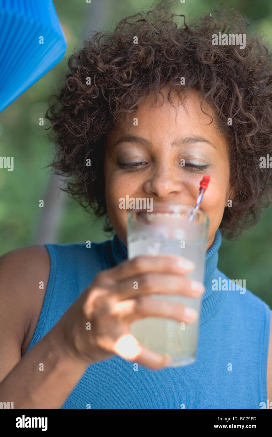 Woman drinking lemonade at a garden party Stock Photo - Alamy