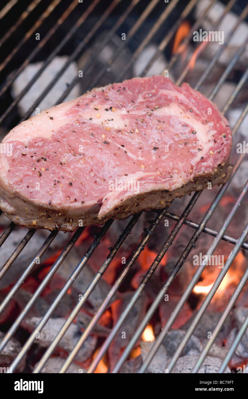 Raw beef steak on a barbecue Stock Photo - Alamy