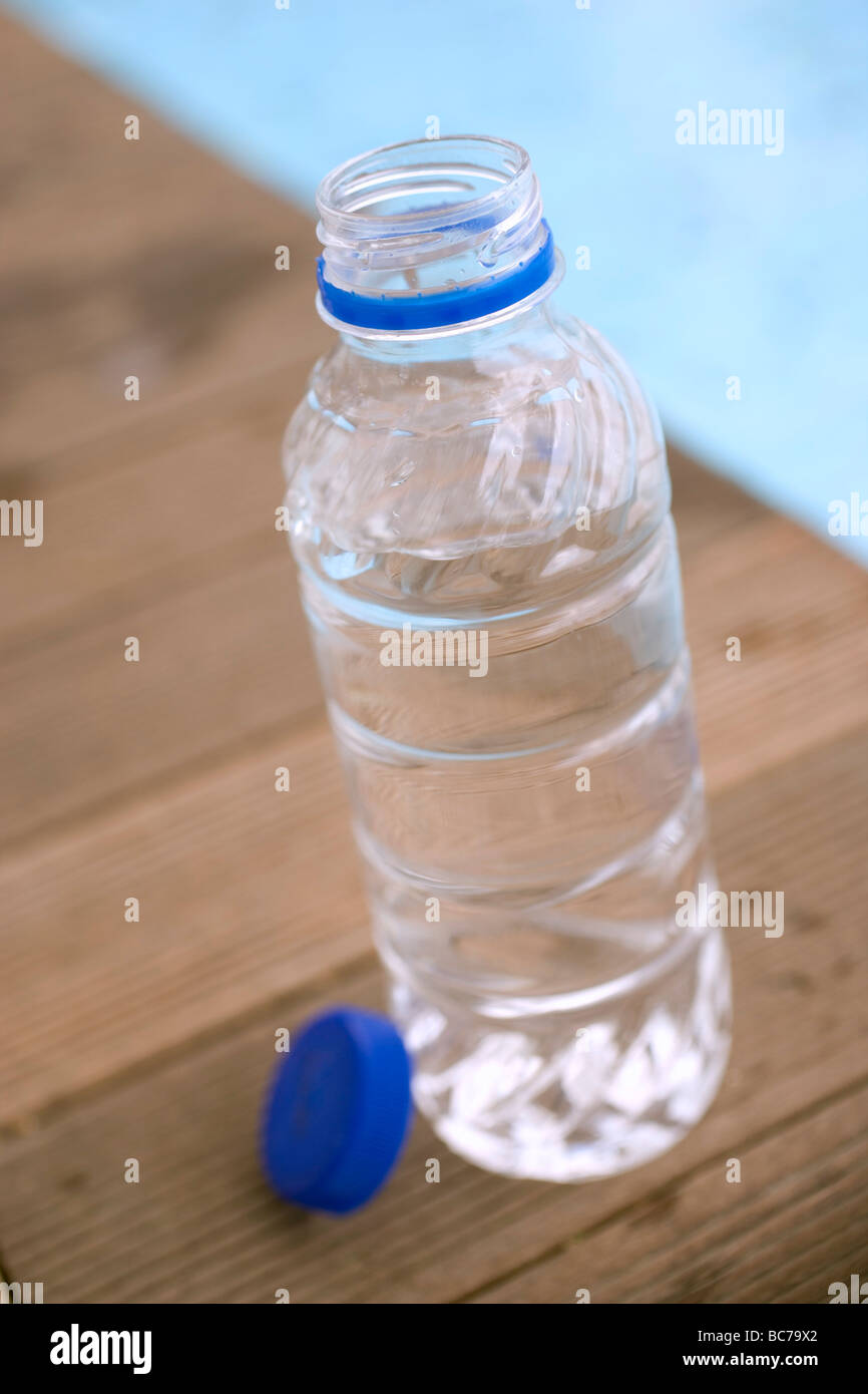 Bottle of water by swimming pool Stock Photo - Alamy