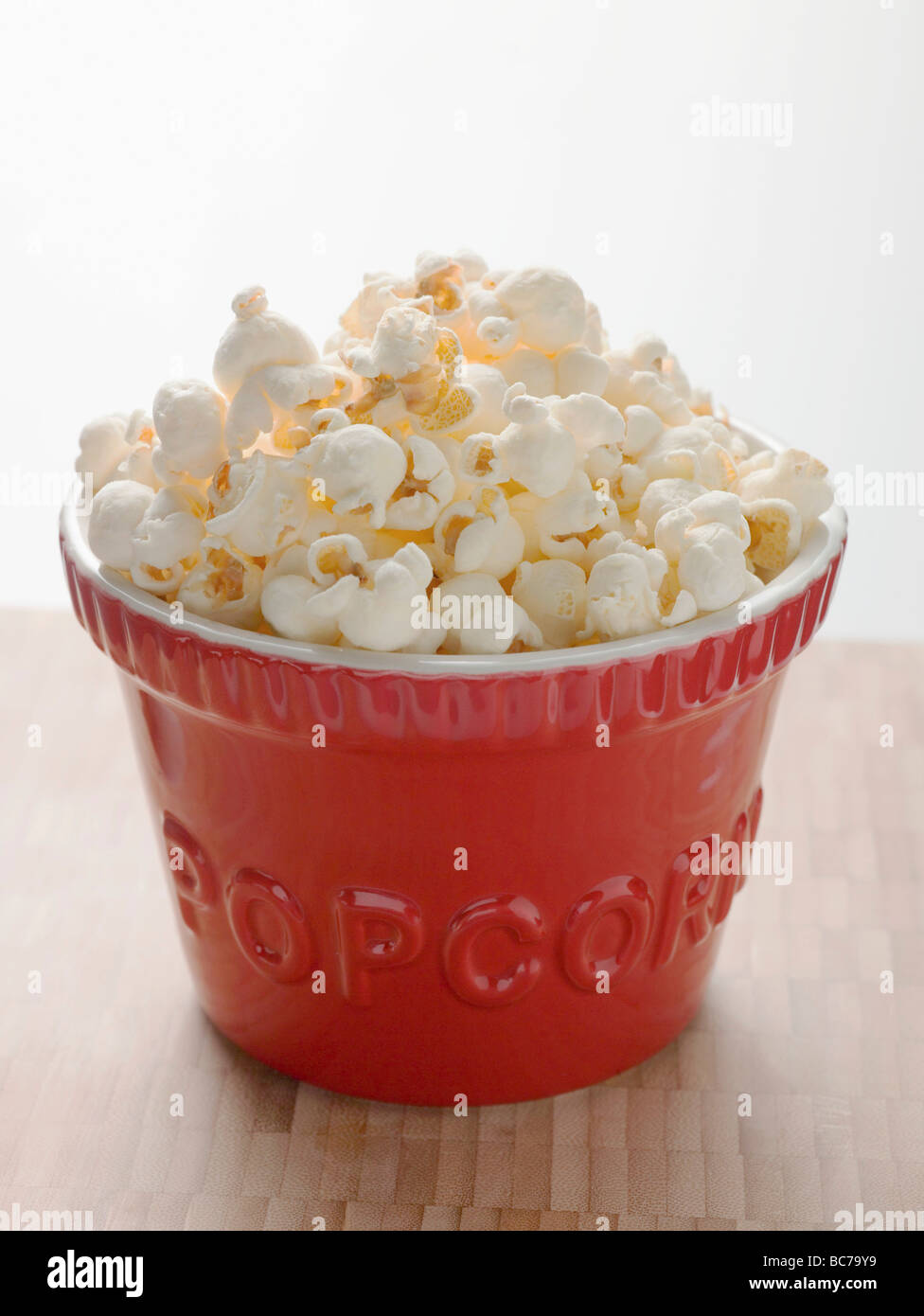 Popcorn in a red bowl Stock Photo - Alamy