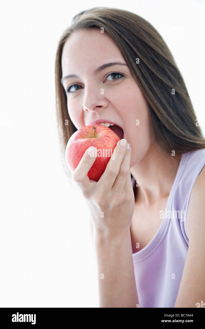 Young woman biting apple, portrait, close-up Stock Photo - Alamy
