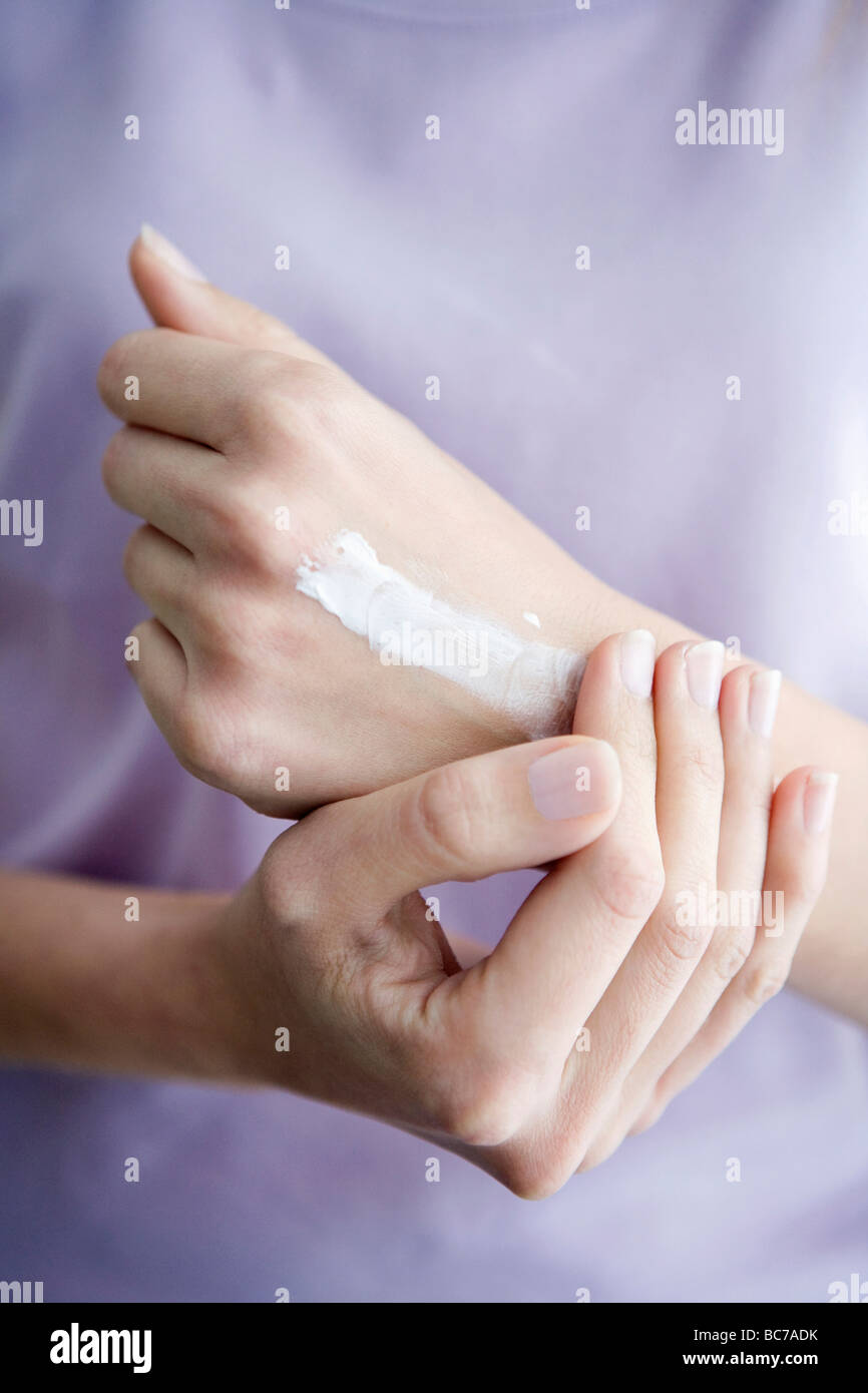 Woman creaming hands hi-res stock photography and images - Alamy