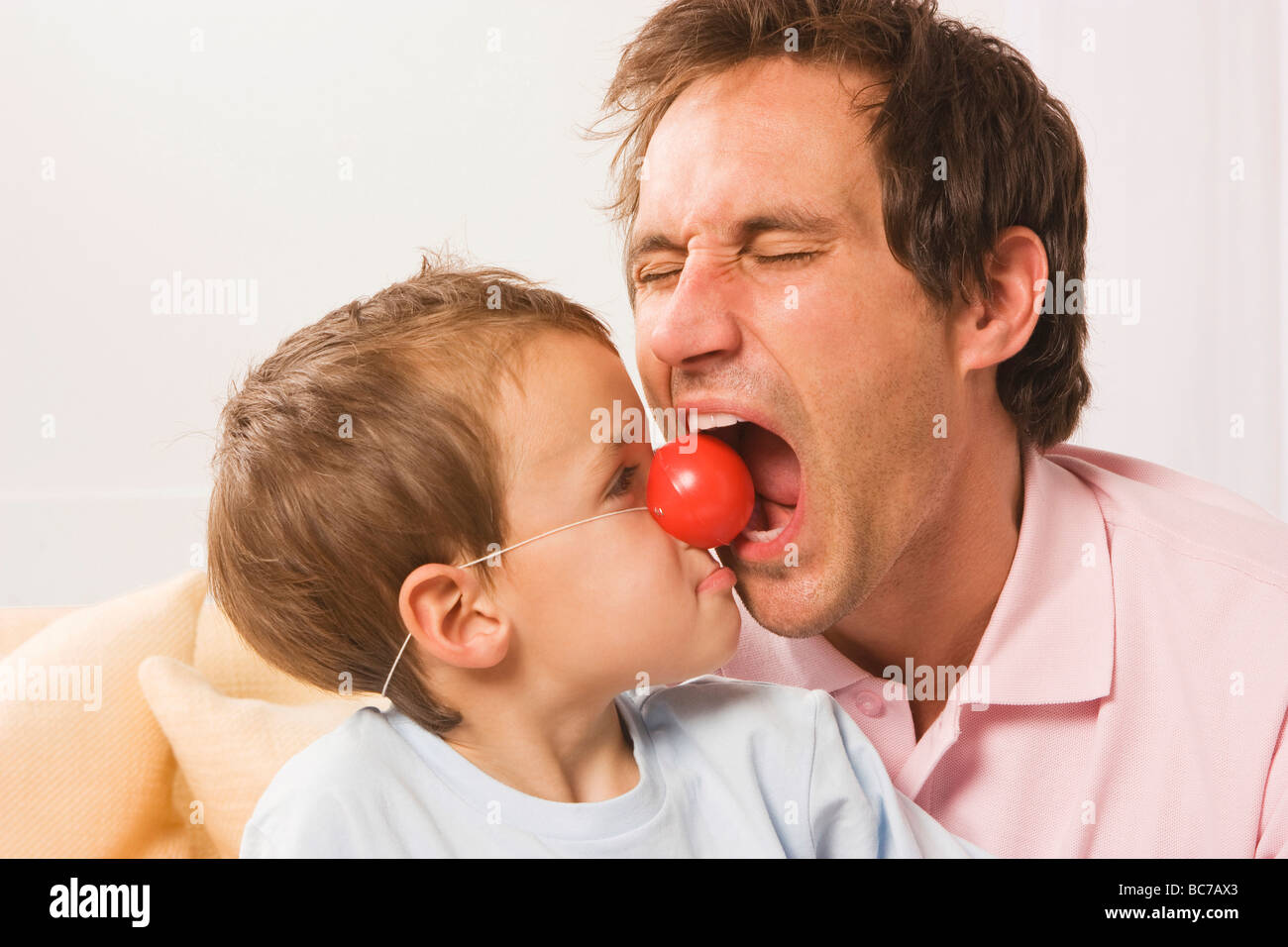 Father and son (4-5), fooling about, boy with clown nose Stock Photo ...