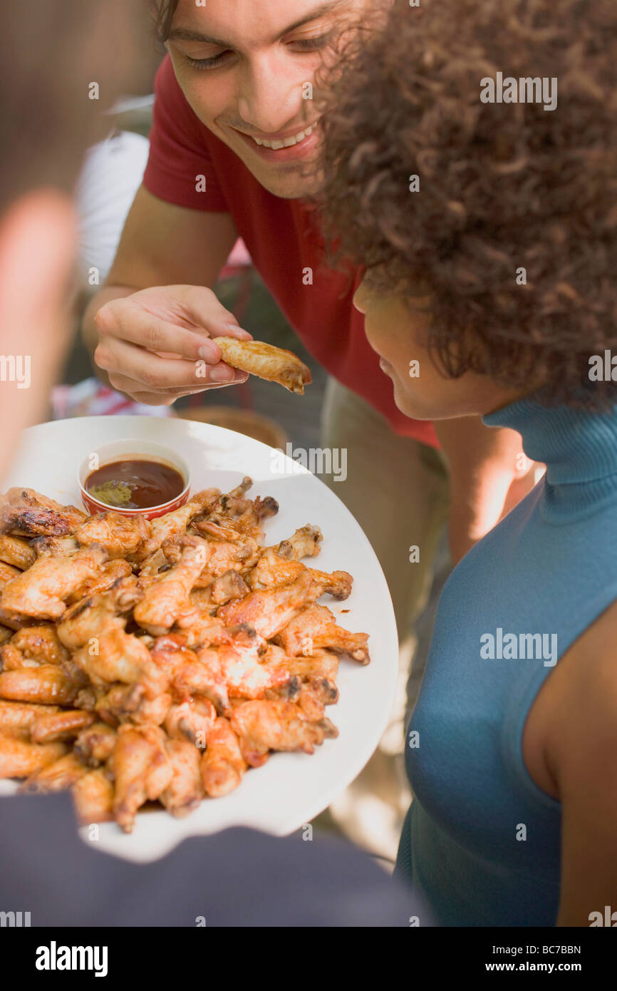 Hand holding grilled chicken wing hi-res stock photography and images ...