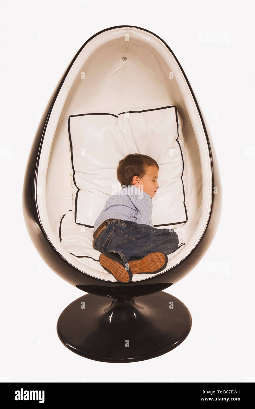 Little boy (4-5) sleeping in design chair Stock Photo - Alamy
