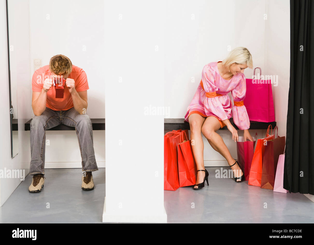 Couple in shop fitting room Stock Photo - Alamy