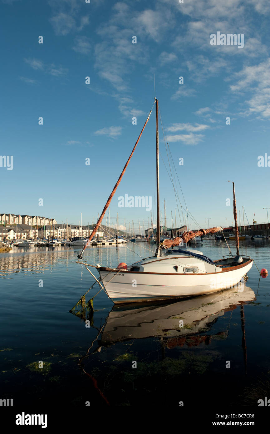 a small yacht moored in Aberystwyth harbour marina at high tide summer ...