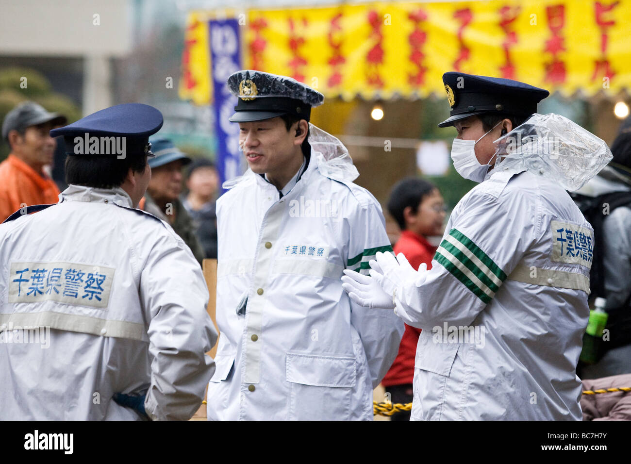 Policemen in protective clothing policing a festival in Japan Stock ...