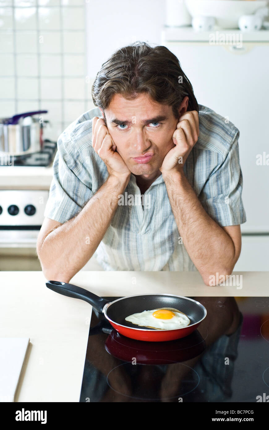 man frying egg Stock Photo - Alamy