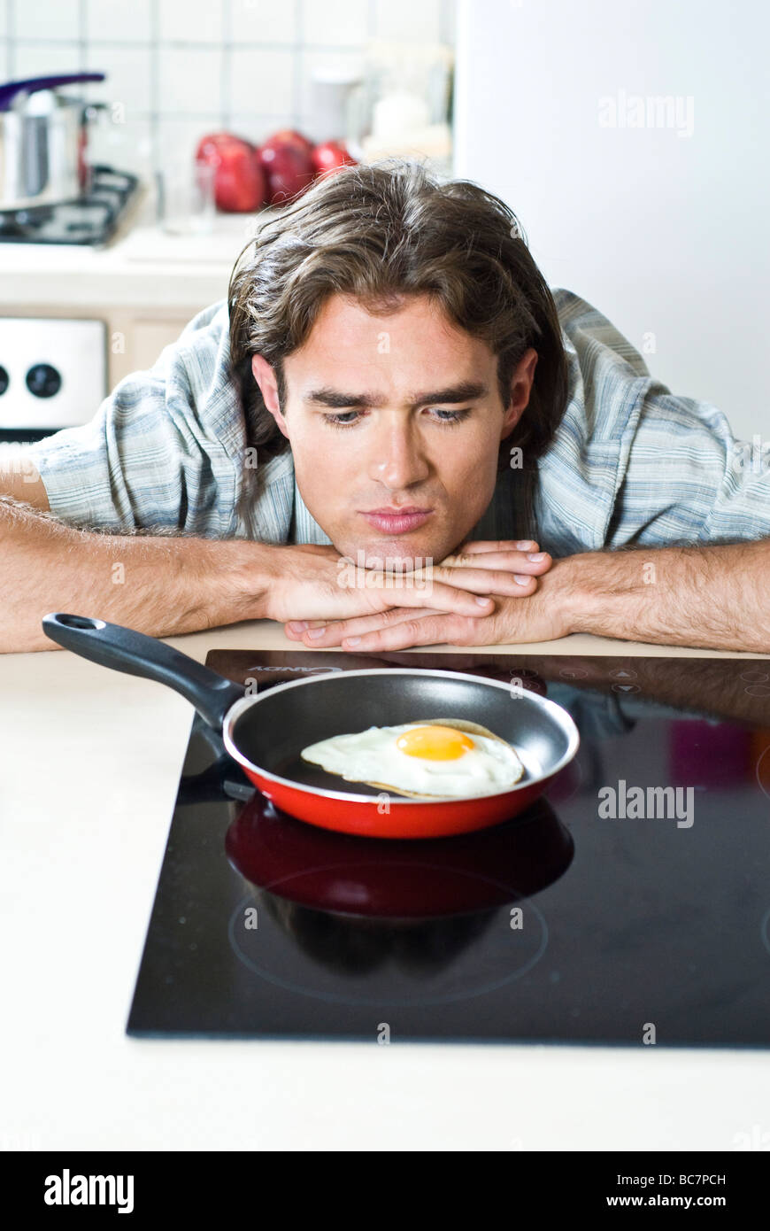 man frying egg Stock Photo - Alamy
