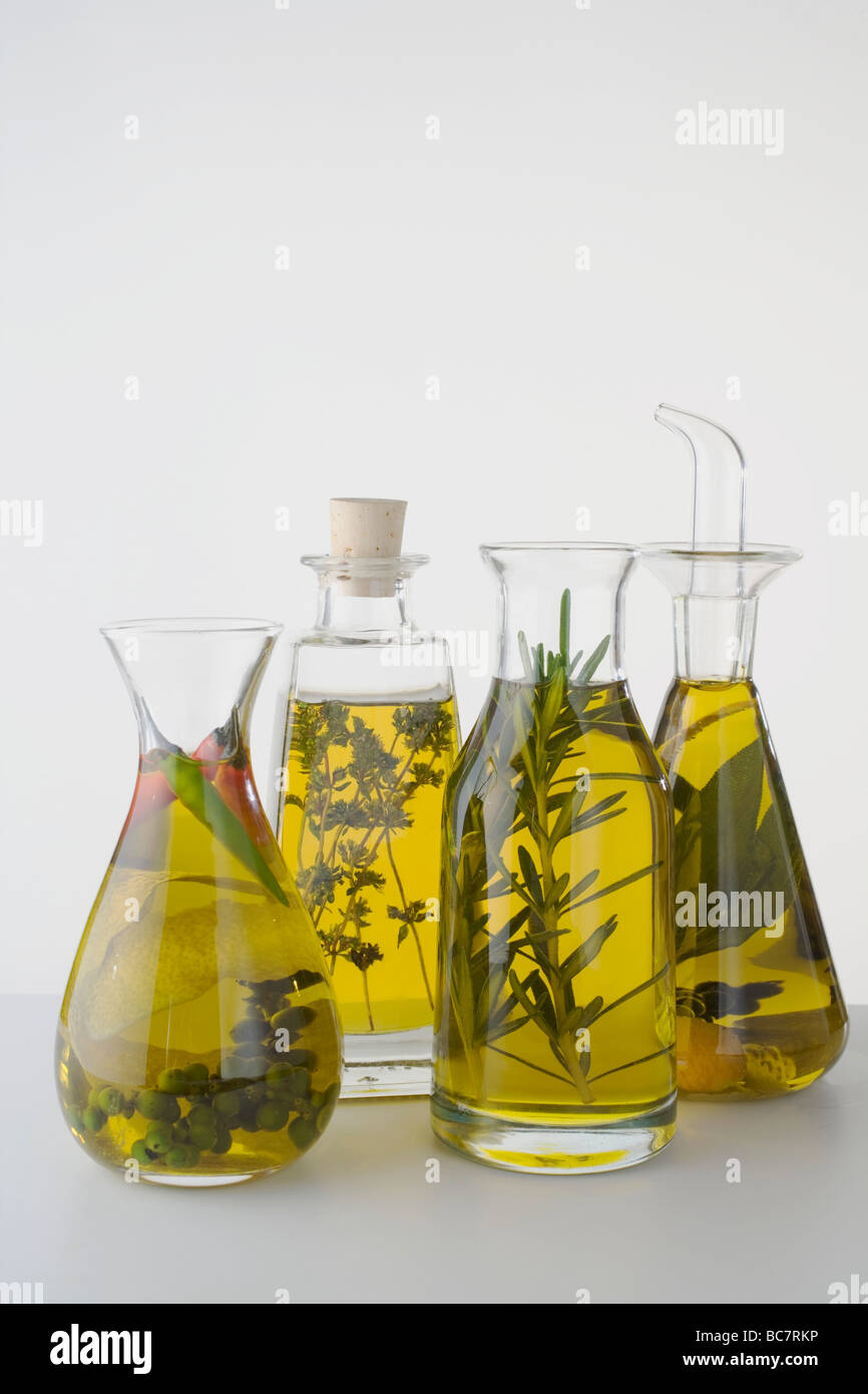 Four different herb oils in bottles Stock Photo - Alamy