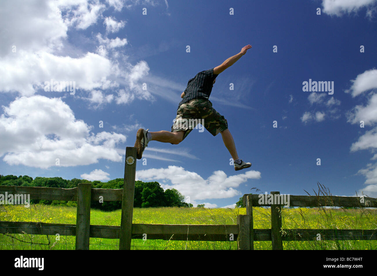 Man jumping over the fence. Cotswolds Way near Broadway village Stock ...