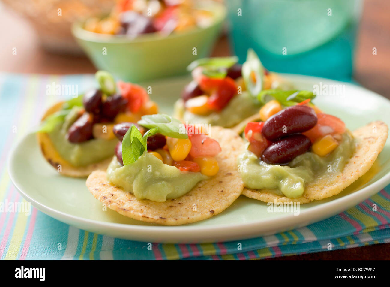 Tortilla chips with guacamole and salsa Stock Photo - Alamy
