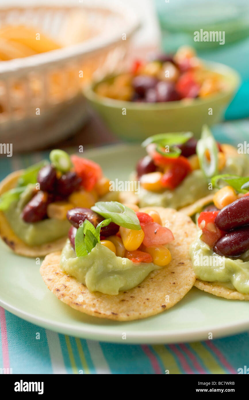 Tortilla chips with guacamole and salsa Stock Photo - Alamy