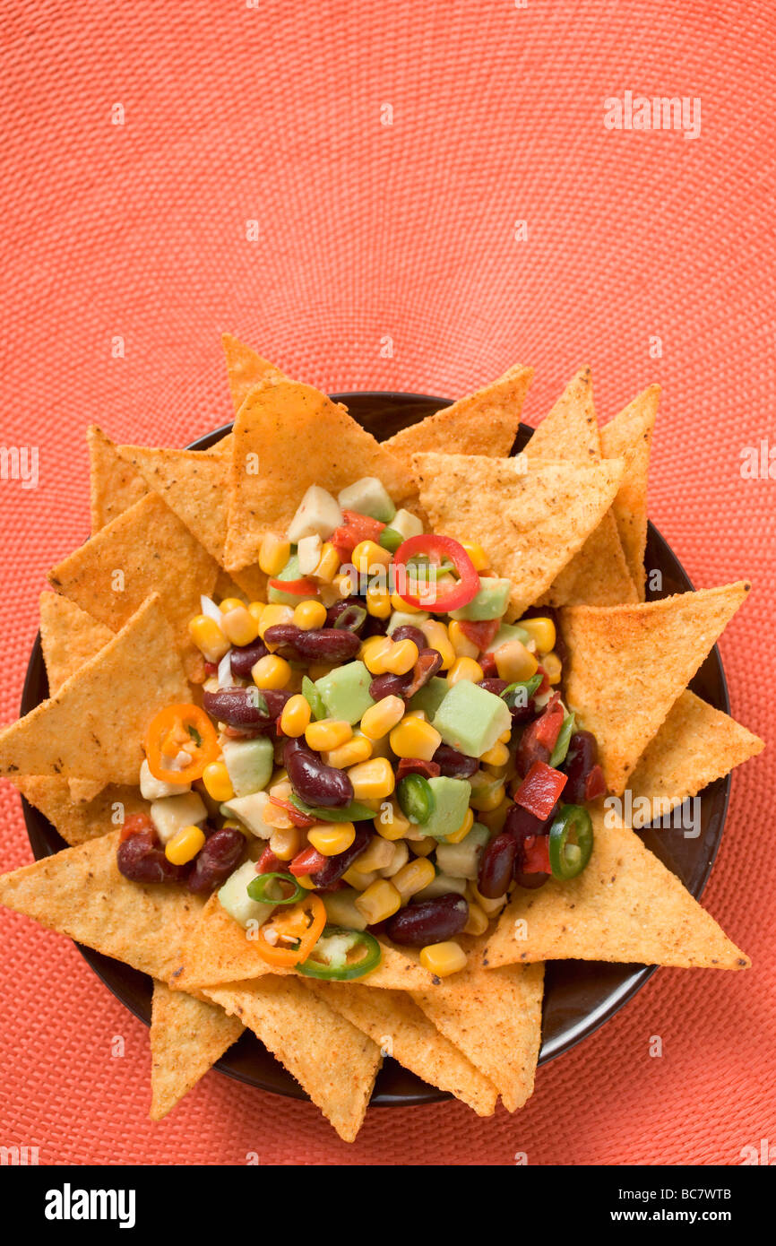 Nachos with beans, sweetcorn, avocado and chilli rings Stock Photo - Alamy