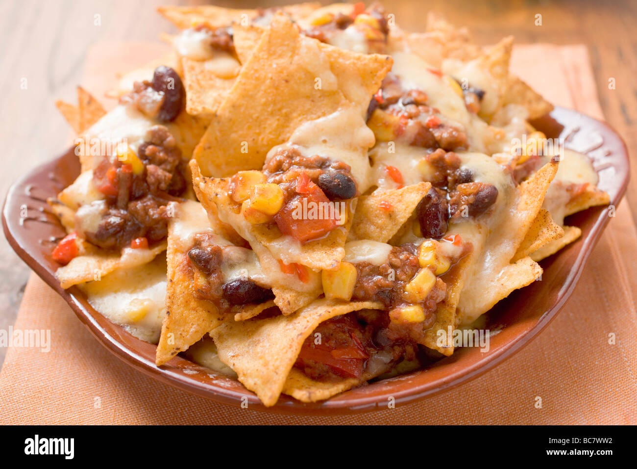 Tortilla chips with melted cheese, beans and mince Stock Photo - Alamy
