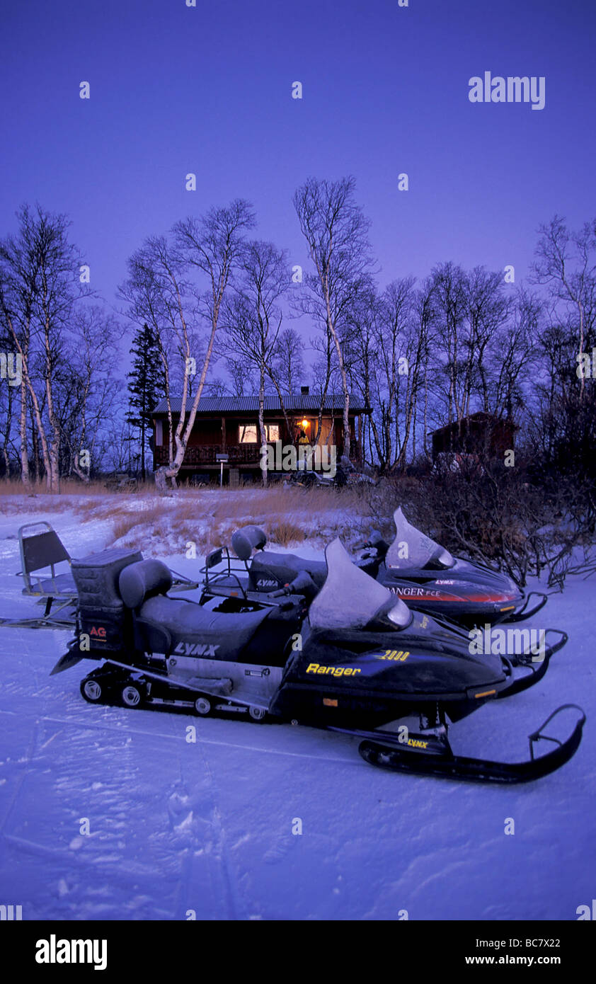 Snowmobiles outside a cabin at night, Sweden Stock Photo - Alamy