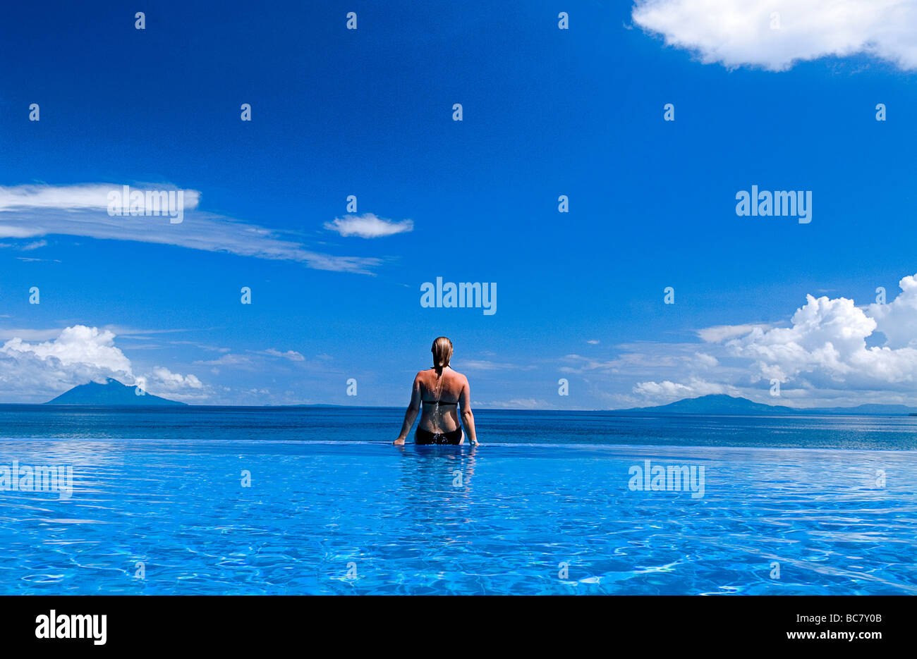Relaxing in Infinity Pool at a holiday resort in Indonesia Stock Photo ...