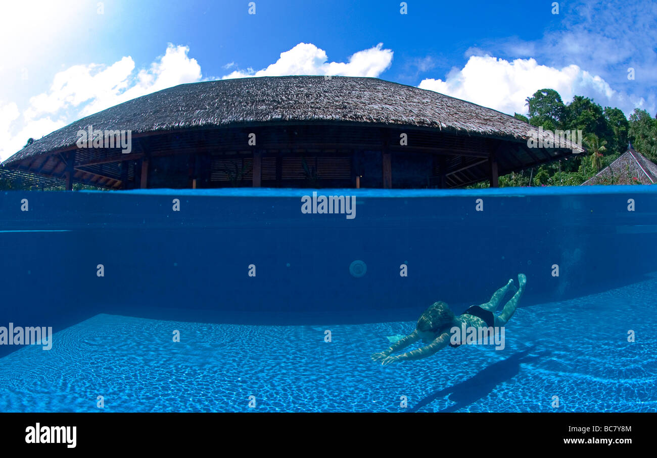 Underwater view of a woman who has just dived into an Infinity Pool ...