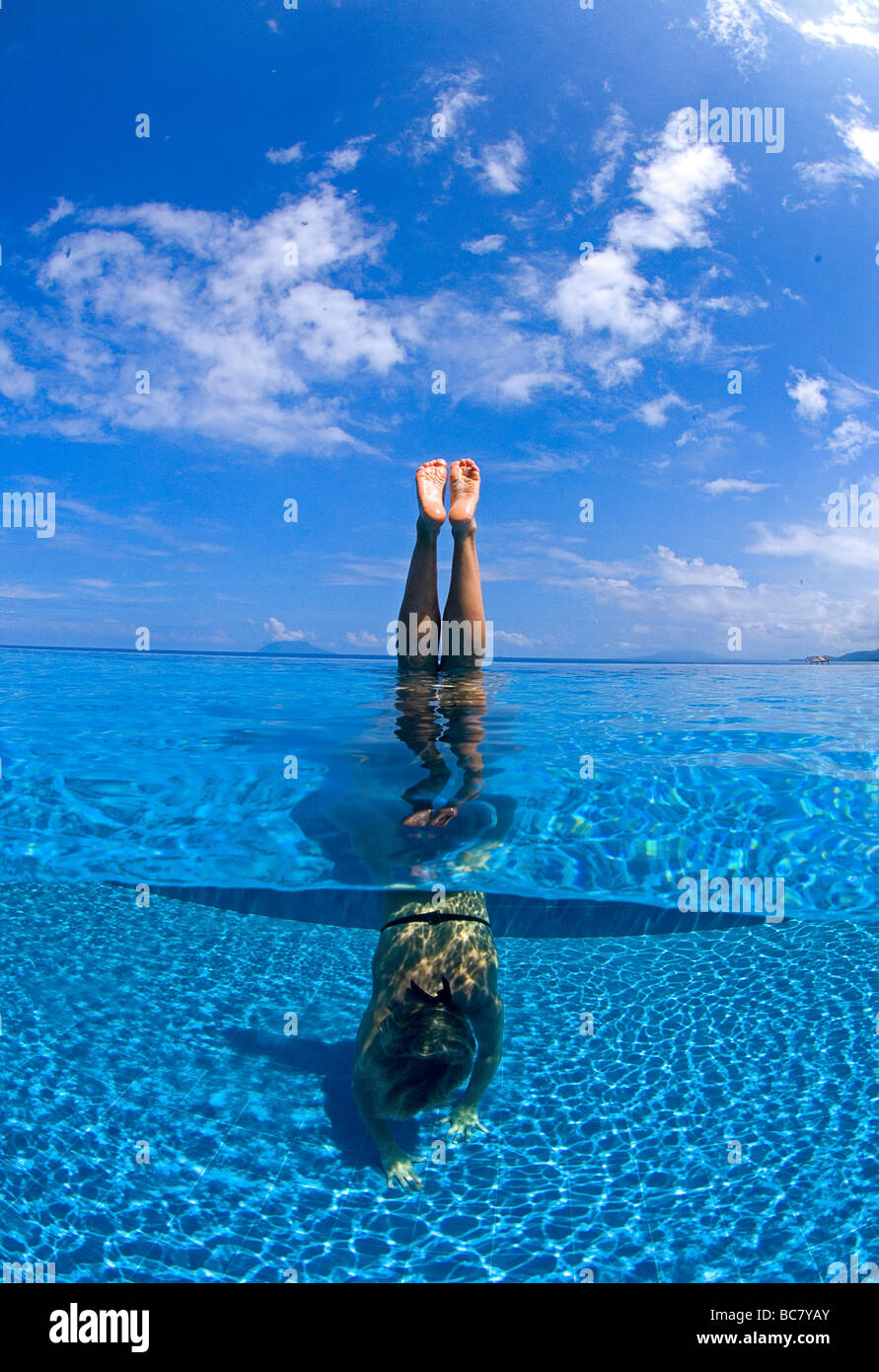 Relaxing in Infinity Pool - wpman doing an underwater handstand Stock ...
