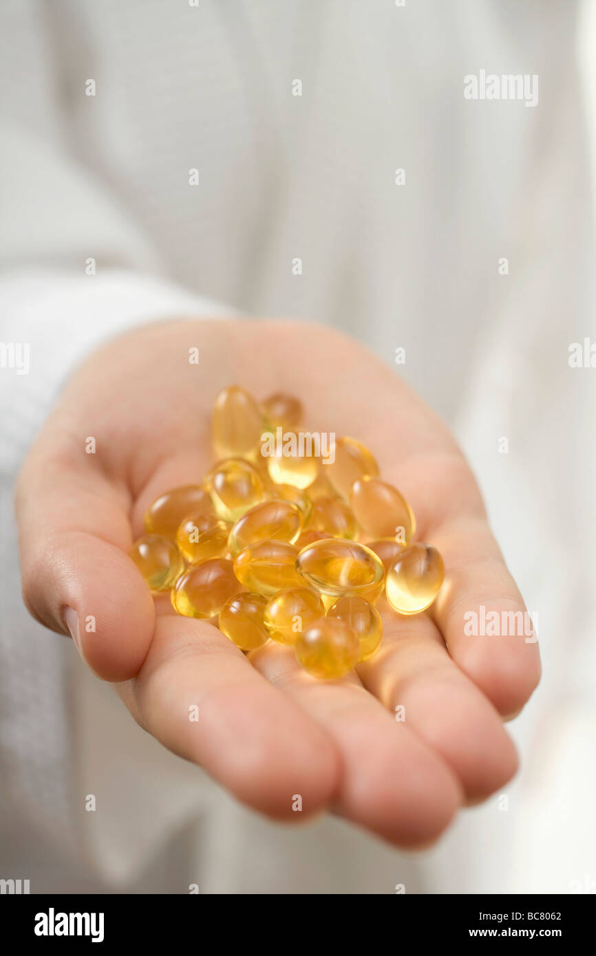 Hand holding vitamin capsules Stock Photo - Alamy