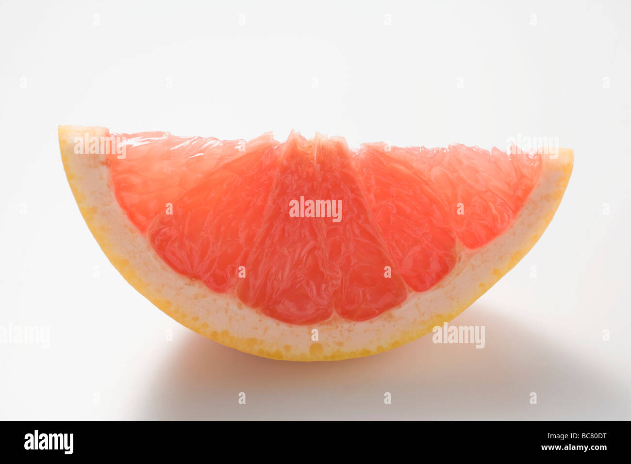 Wedge of pink grapefruit Stock Photo - Alamy