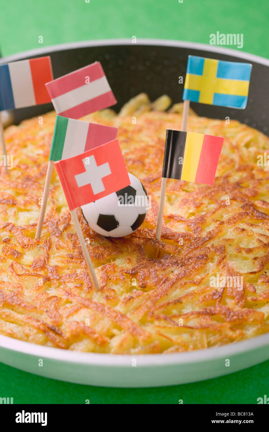 Rösti with toy football and European flags in frying pan Stock Photo ...