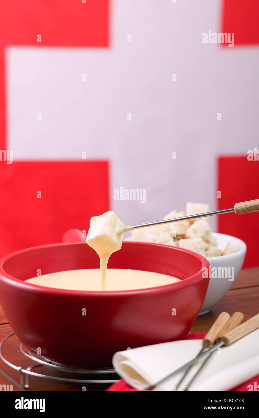 Cheese fondue in front of Swiss flag Stock Photo - Alamy