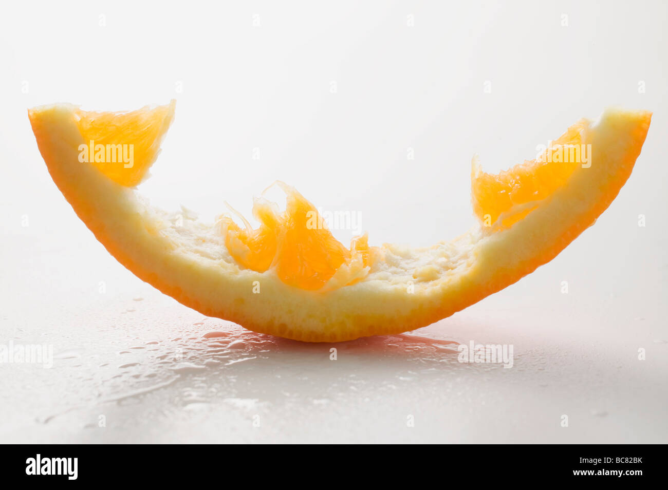 Wedge of orange, eaten Stock Photo - Alamy
