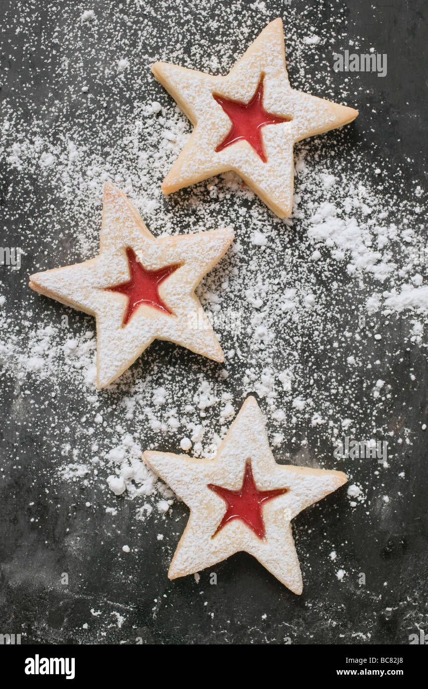 Three jam biscuits with icing sugar Stock Photo - Alamy