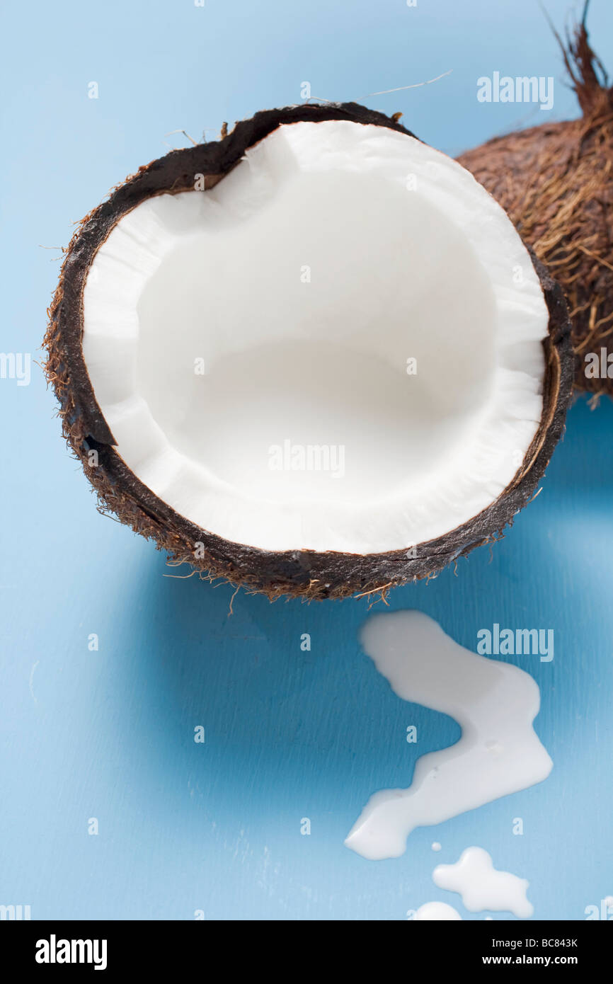 Half a coconut with coconut milk Stock Photo - Alamy