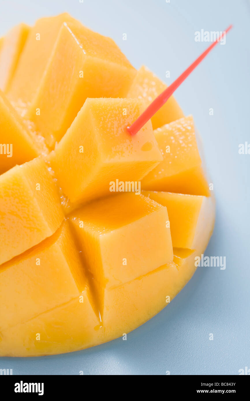 Diced mango still attached to the skin with cocktail stick Stock Photo ...