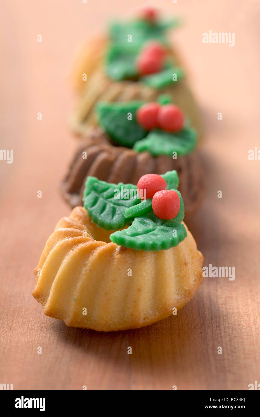 Small ring cakes with marzipan leaves for Christmas Stock Photo - Alamy