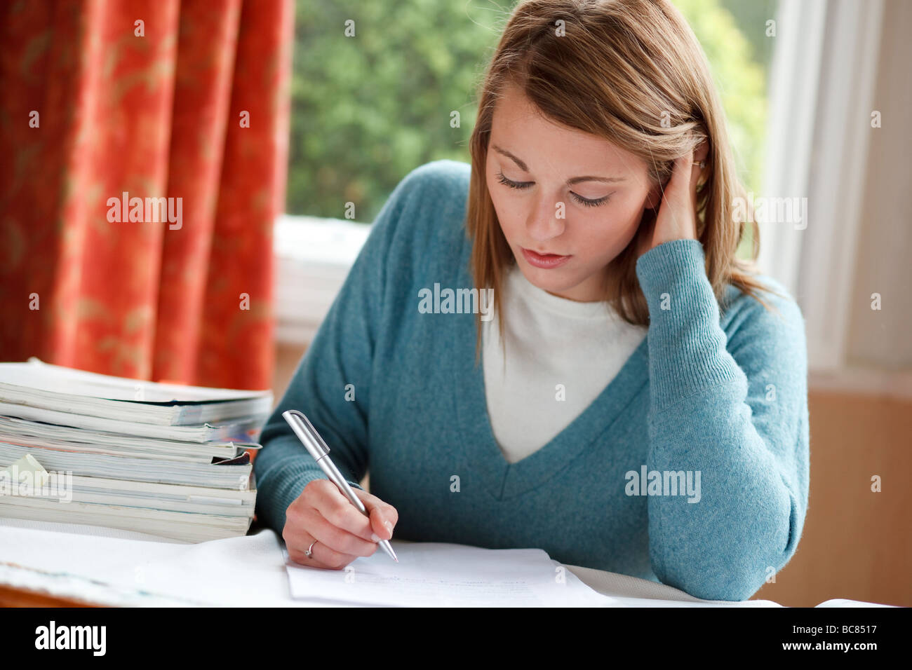 young female teacher marking work Stock Photo - Alamy
