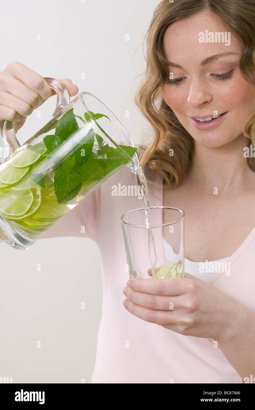Woman pouring lemonade into glass Stock Photo - Alamy