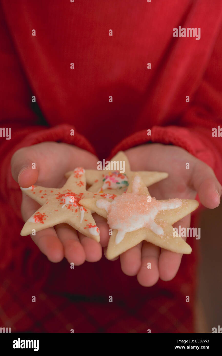 Child's hands holding Christmas biscuit Stock Photo - Alamy