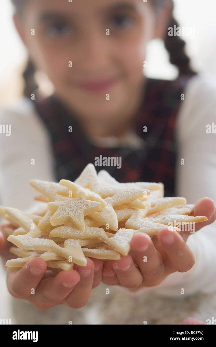 Girl with her hands full of star biscuits Stock Photo - Alamy