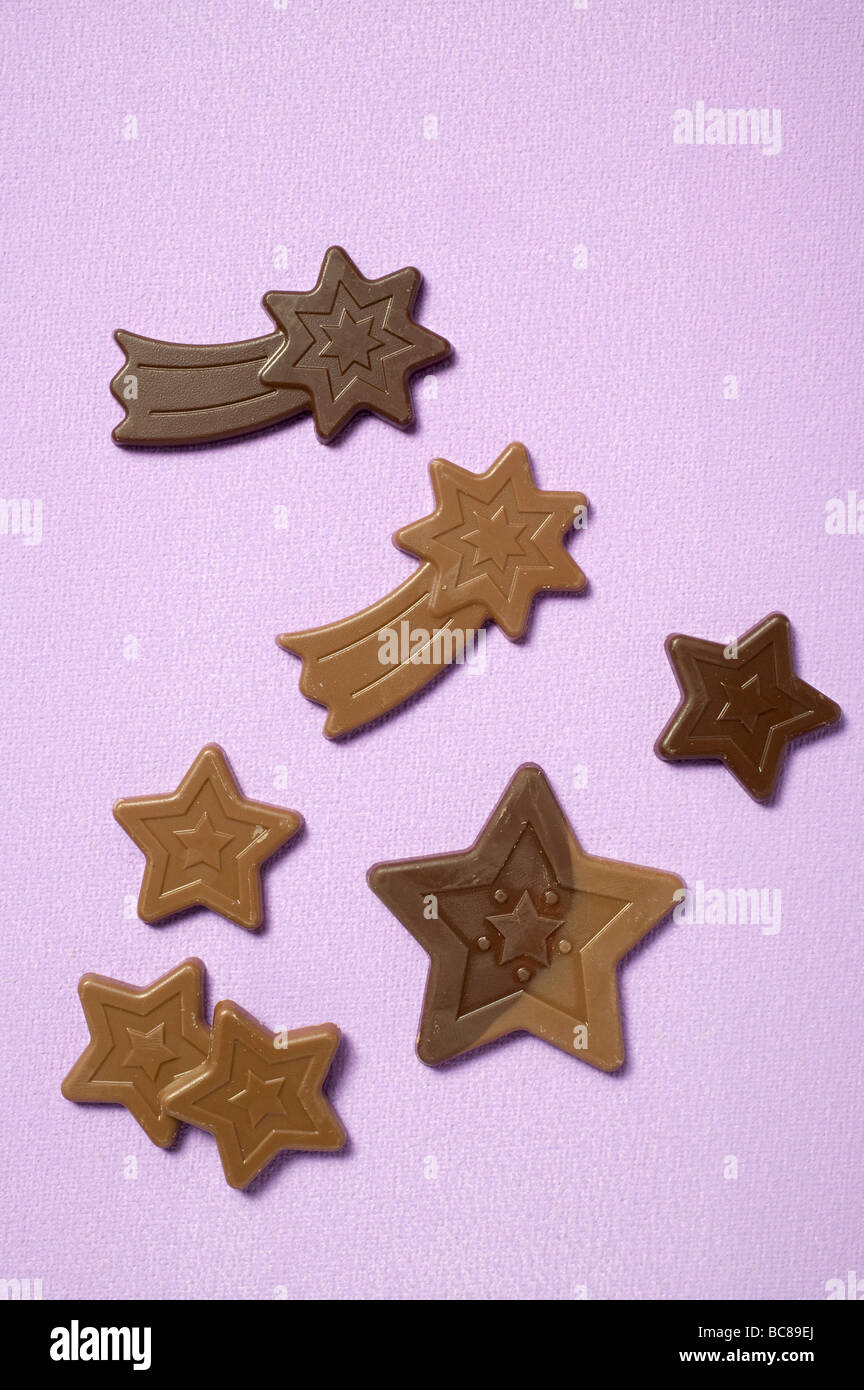 Chocolate stars on purple background Stock Photo - Alamy