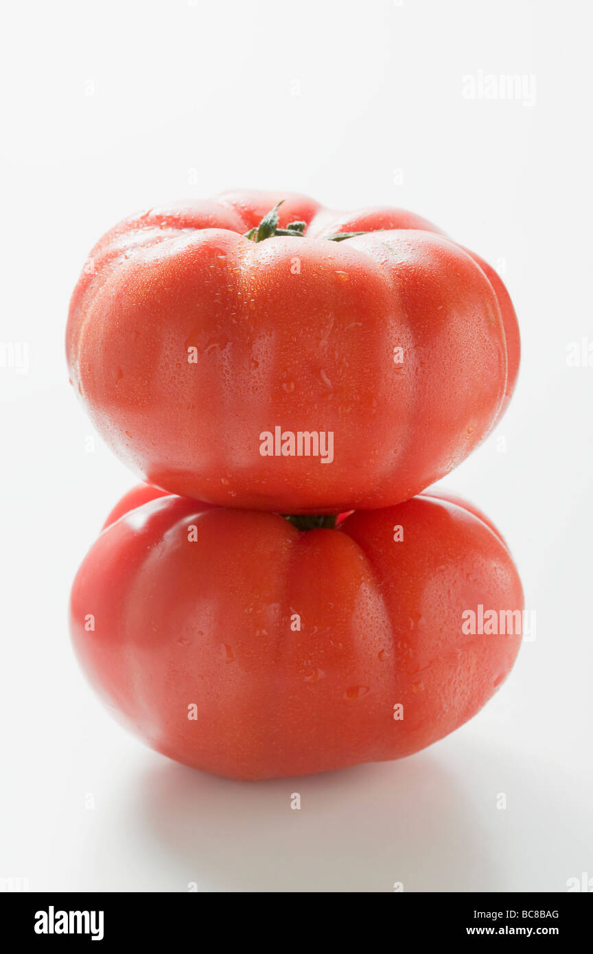 Two beefsteak tomatoes, one on top of the other Stock Photo - Alamy